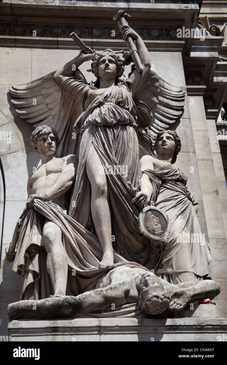 A statue of an angel standing on a corpse with two other people by her ...