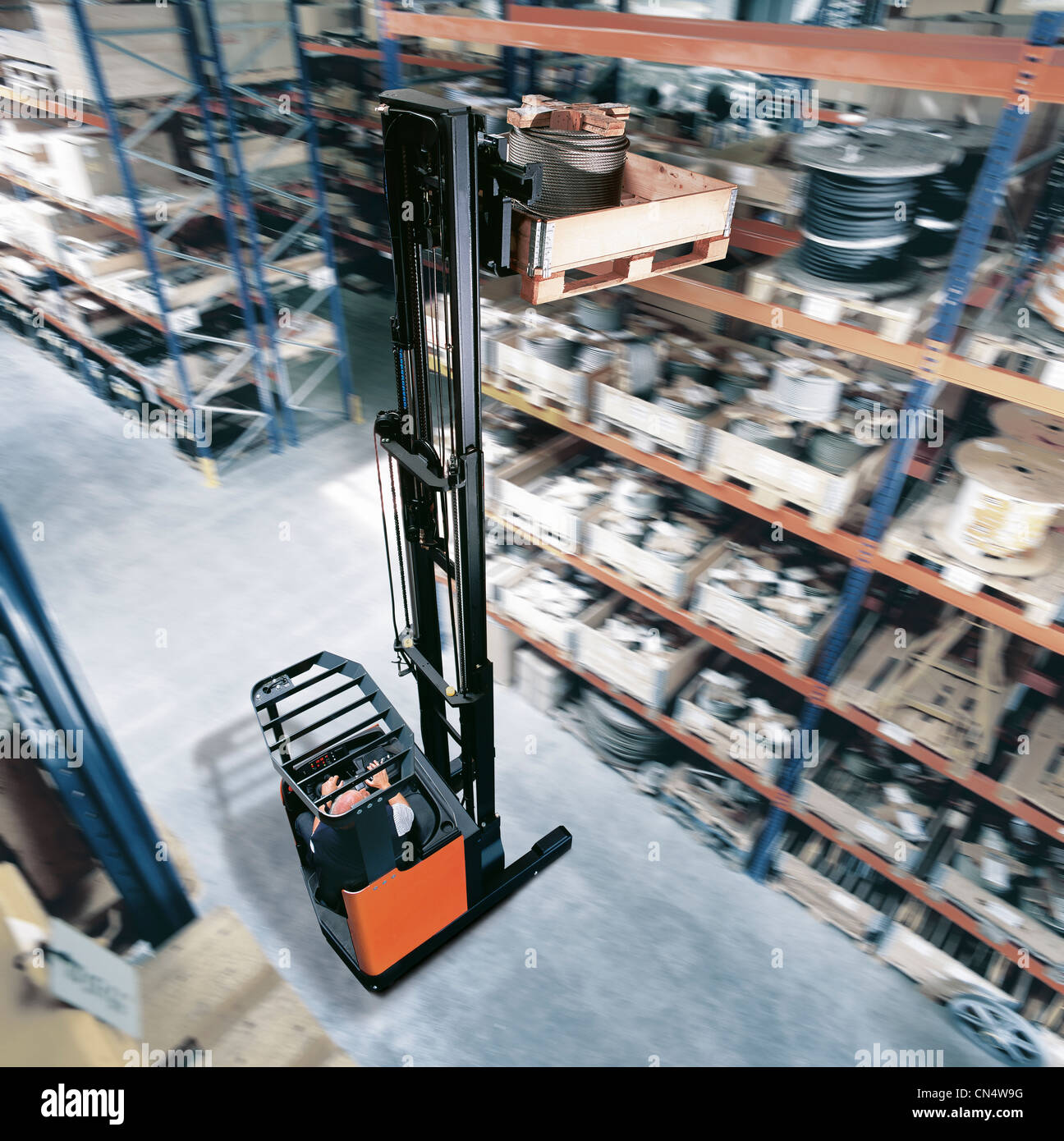 Pallet truck working at the warehouse Stock Photo - Alamy