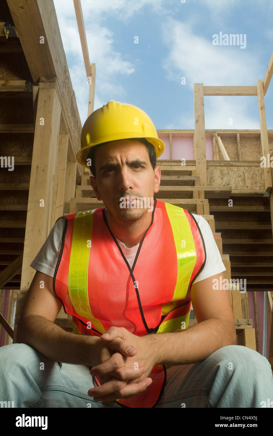 Portrait of a Construction Worker Sitting on Unfinished Stairs of a new ...