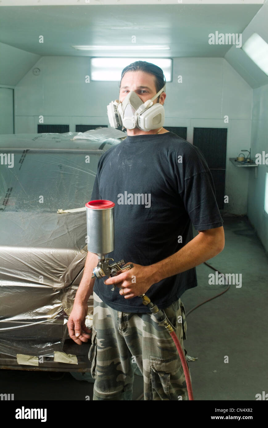 Portrait of a Mechanic in a Body Shop with an Automotive Paint Spray ...