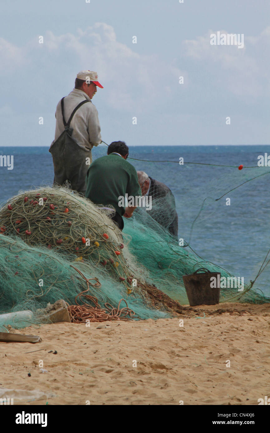 Fisherman working in a beach Stock Photo - Alamy
