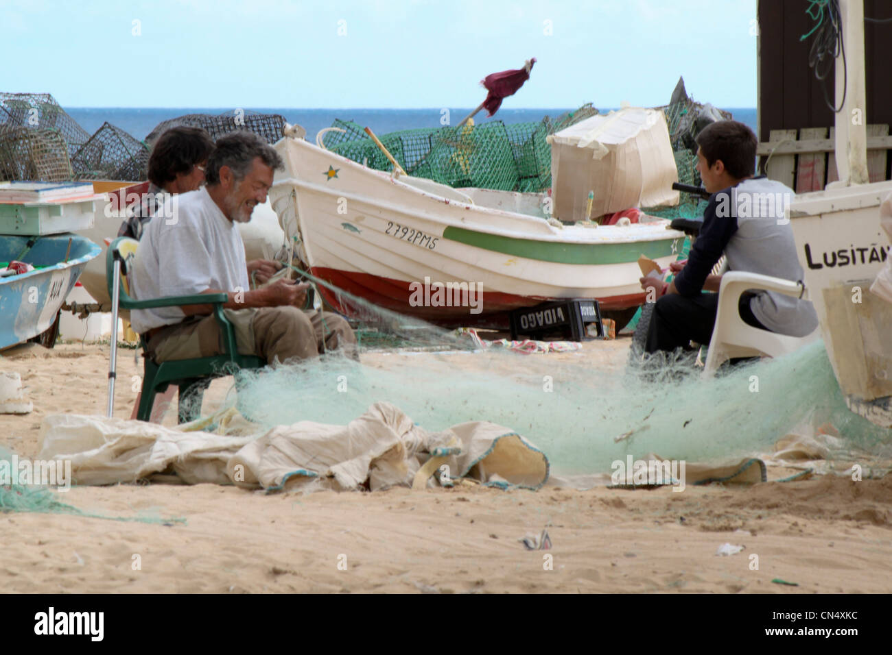 Fisherman working in the beach Stock Photo - Alamy