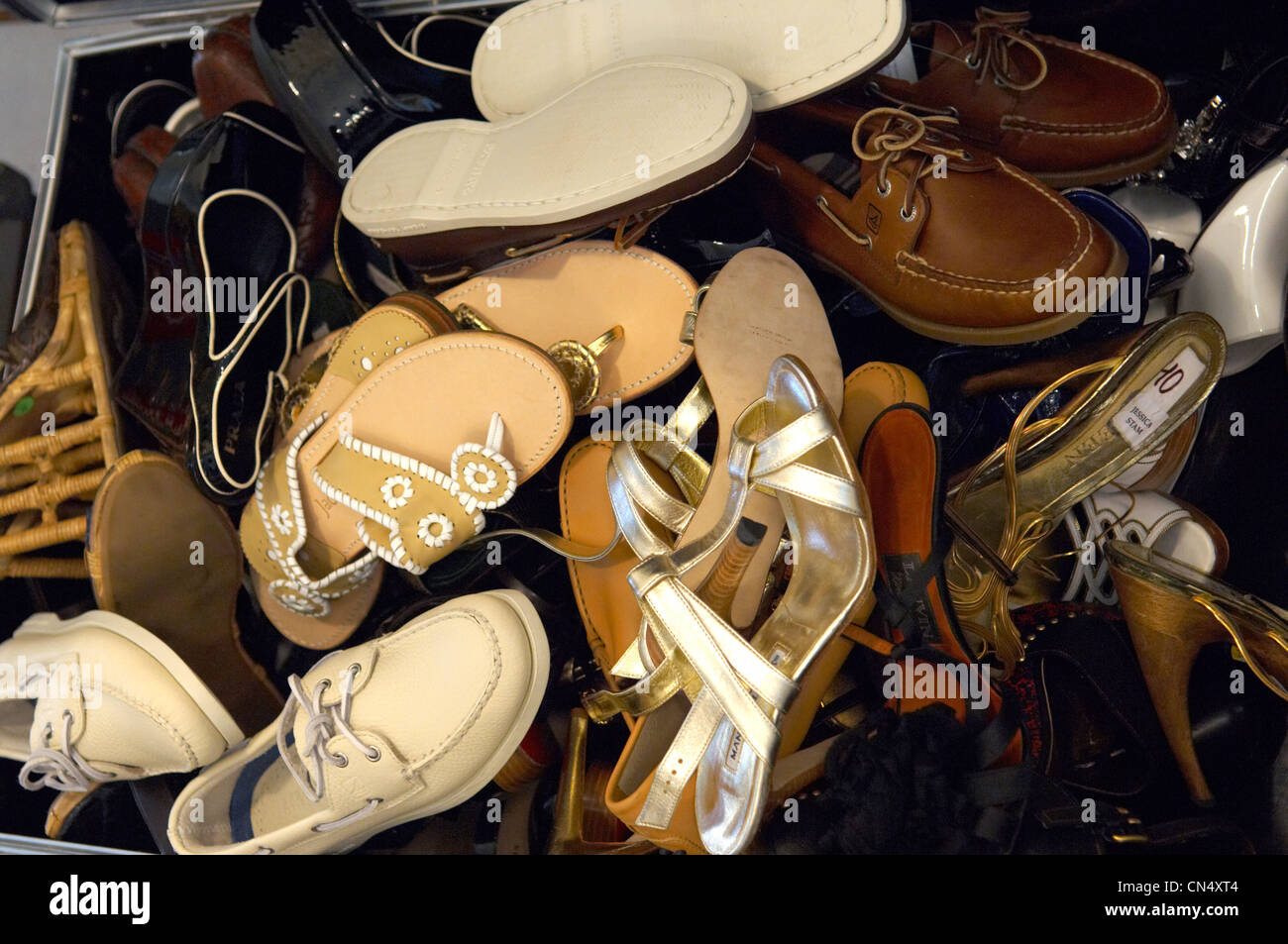 Shoes in a pile. A mixed jumble of footwear. Random pairs of shoes in a ...