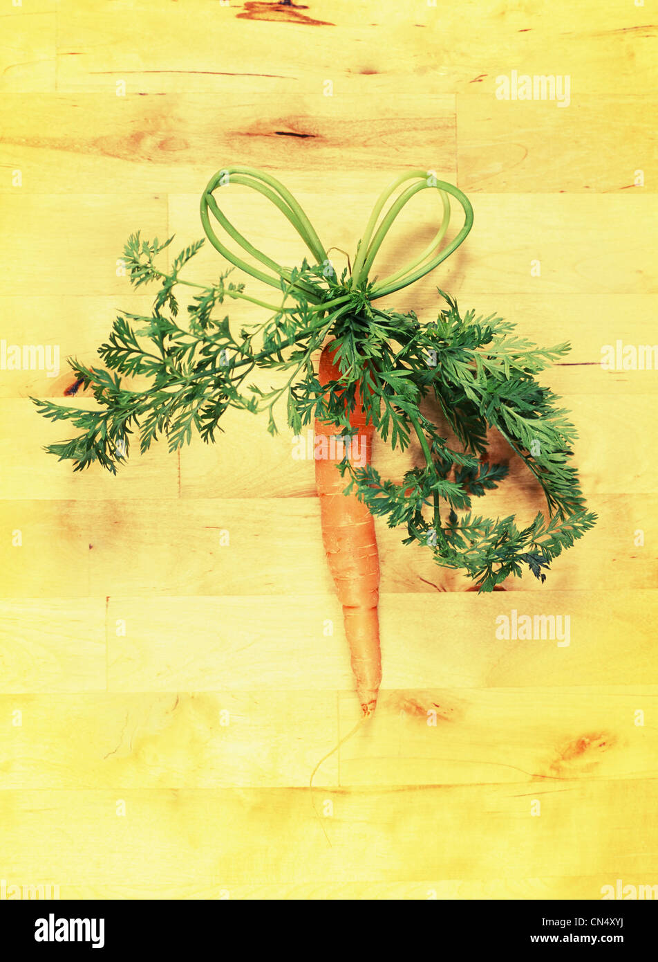 Carrot leaves tied in a bow Stock Photo - Alamy