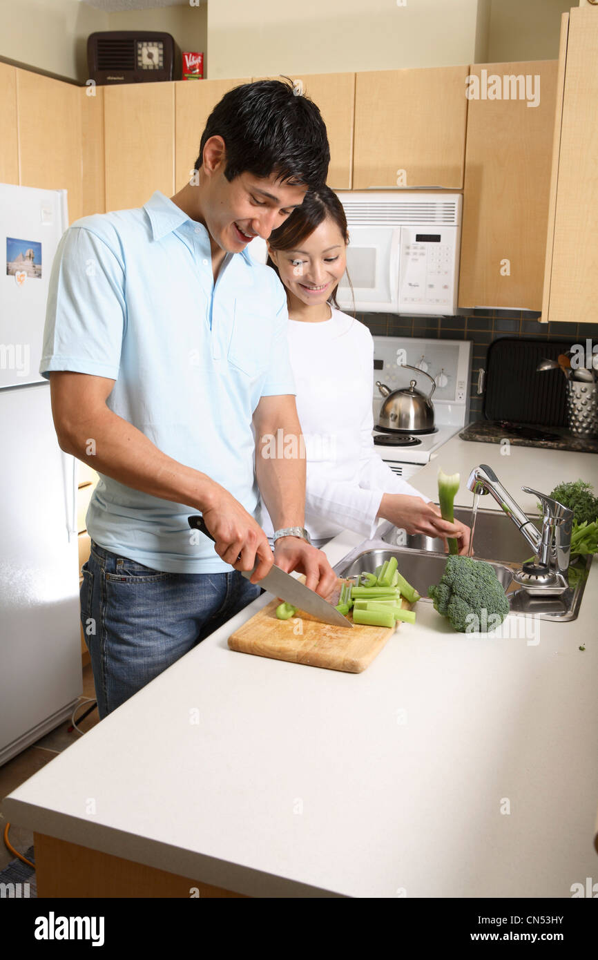Couple Cooking together in a Condo, Vancouver, British Columbia Stock ...