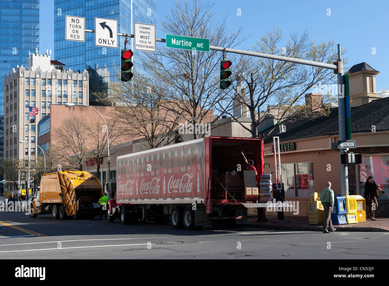 A rear-loading truck makes a curbside Coca-cola delivery at a 7-Eleven ...