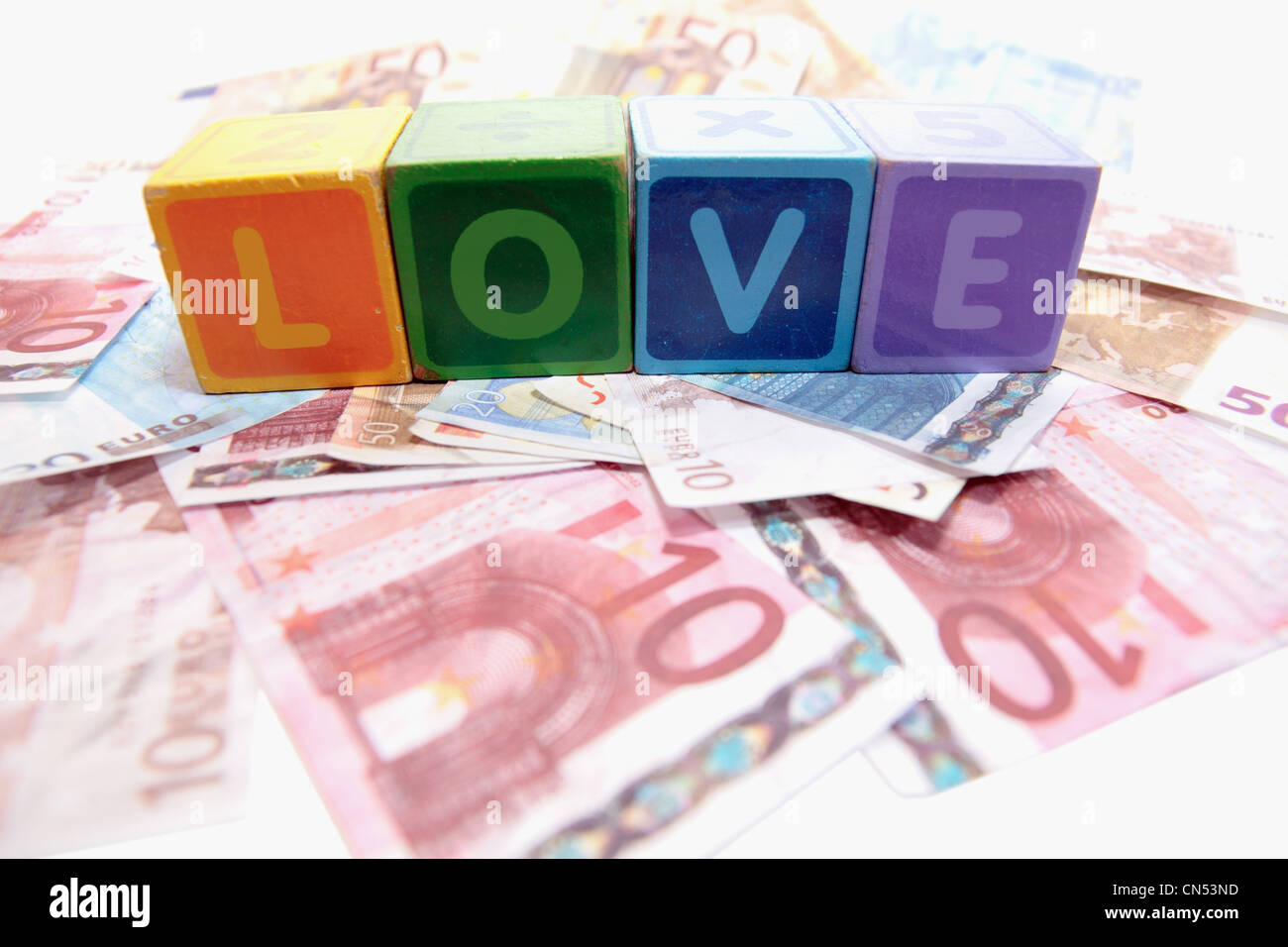 assorted childrens toy letter building blocks on money that spell love ...