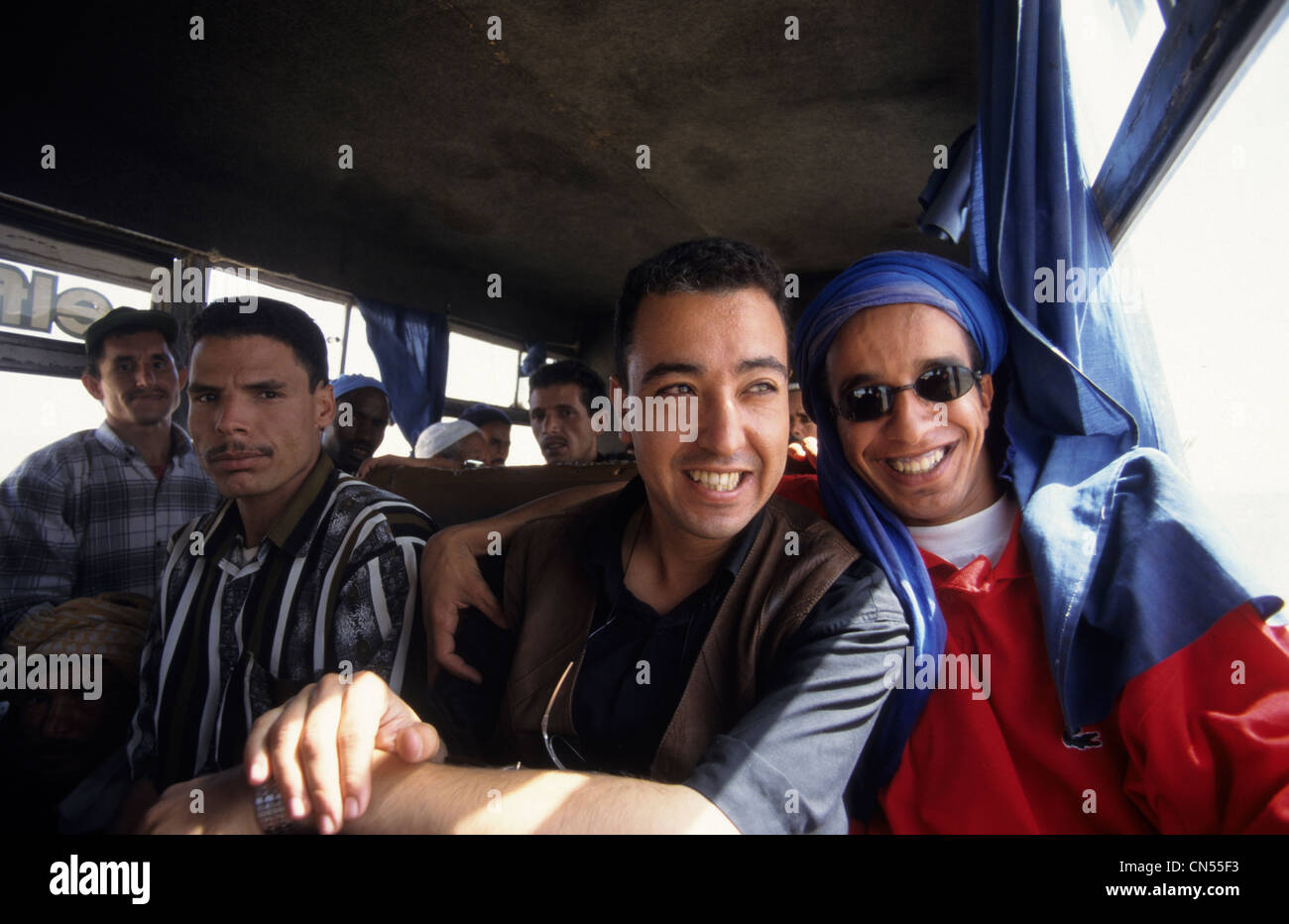 Moroccan passengers traveling in a bus in the Atlas Mountains, Morocco ...