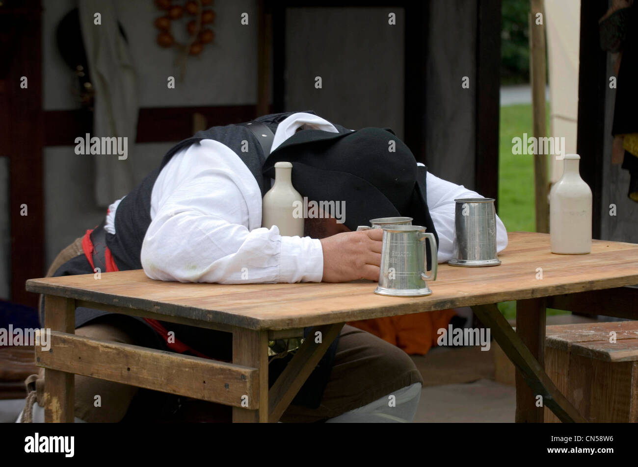 Drunk person in period costume passed out at table Stock Photo - Alamy
