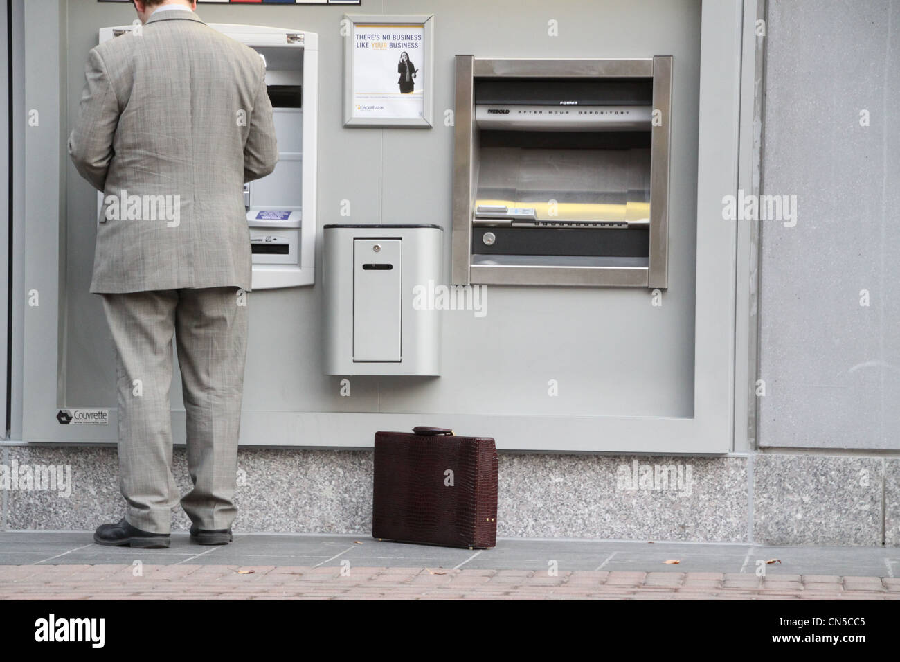 Man making transaction at automated teller machine Stock Photo - Alamy
