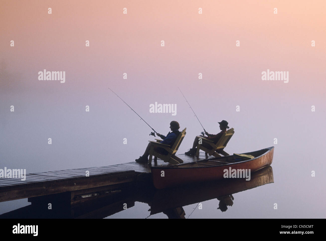Couple Fishing off Dock, Winnipeg River, Pinawa, Manitoba Stock Photo ...