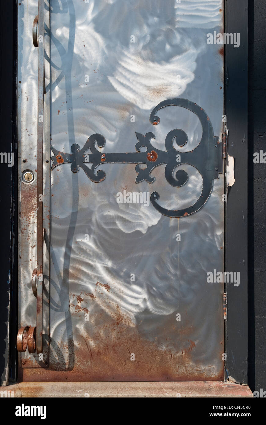 An artistic glass door reflects morning light in front of Armory Arts ...