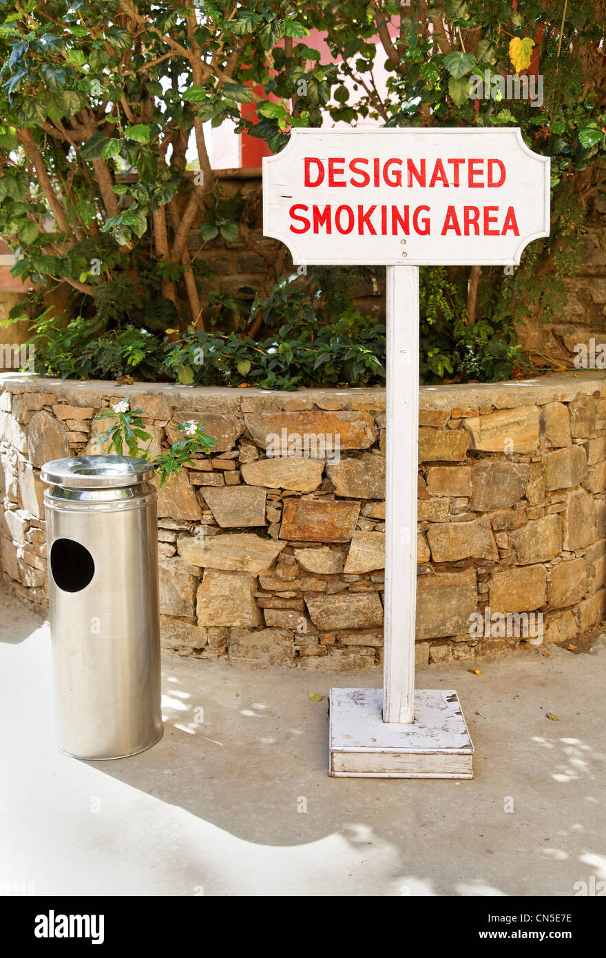 vertical take of a free standing sign and ashtray of a public smoking ...