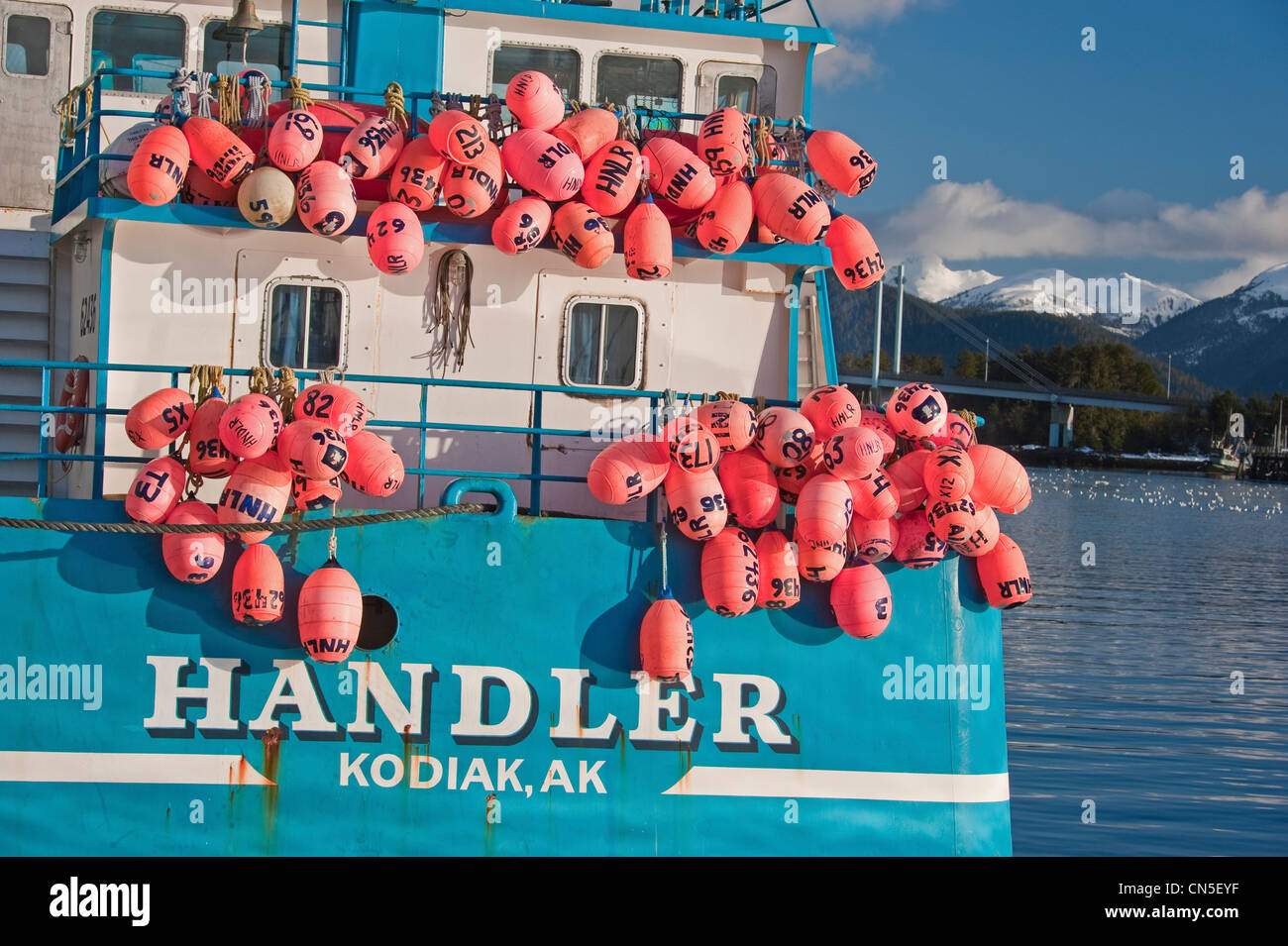 Colorful floats hanging stern of sac roe herring fishery tender docked ...