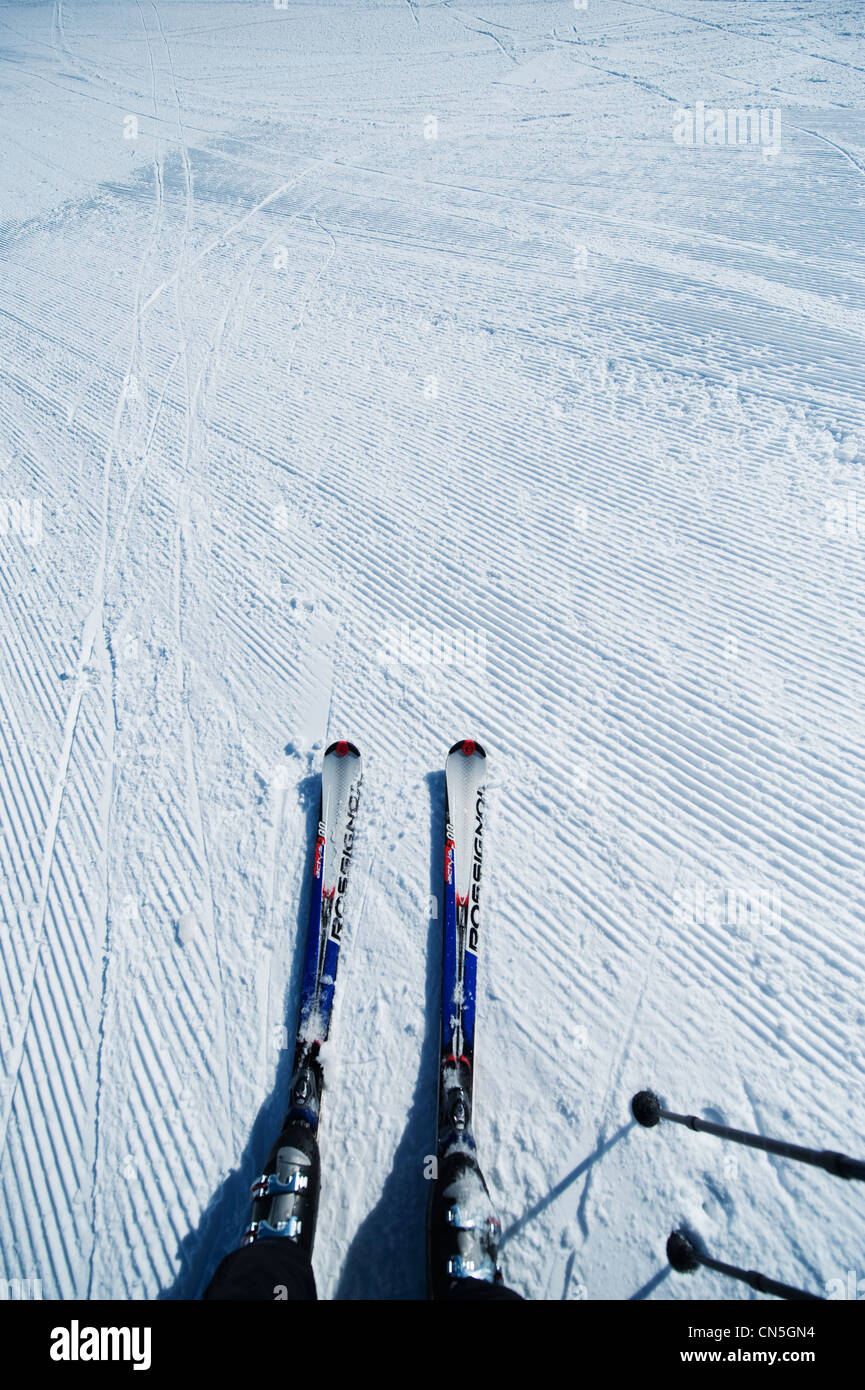 Skis on freshly prepared snow piste Stock Photo - Alamy