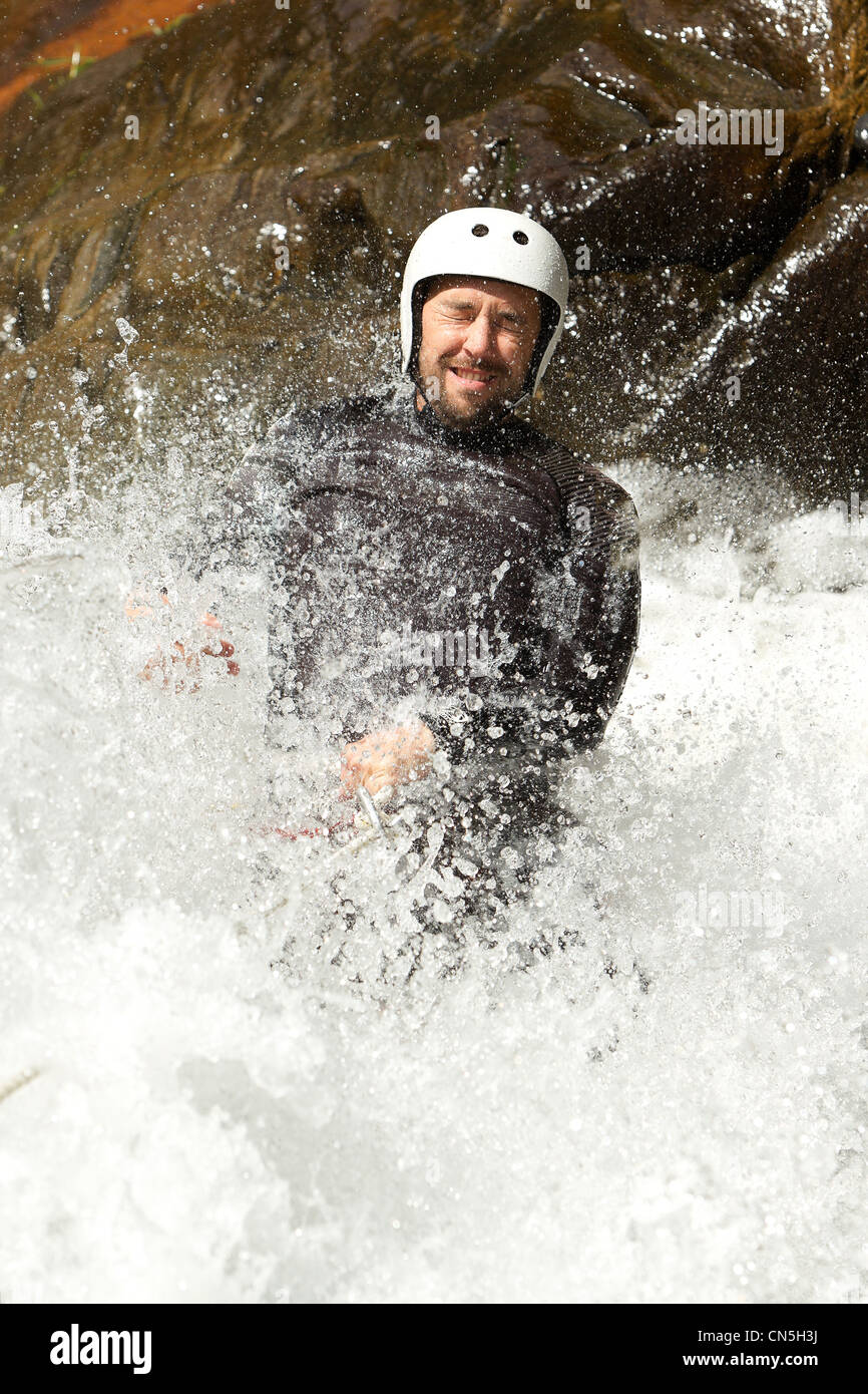 Adult Man Descending Into A Waterfall Shoot From The Water Level Stock ...