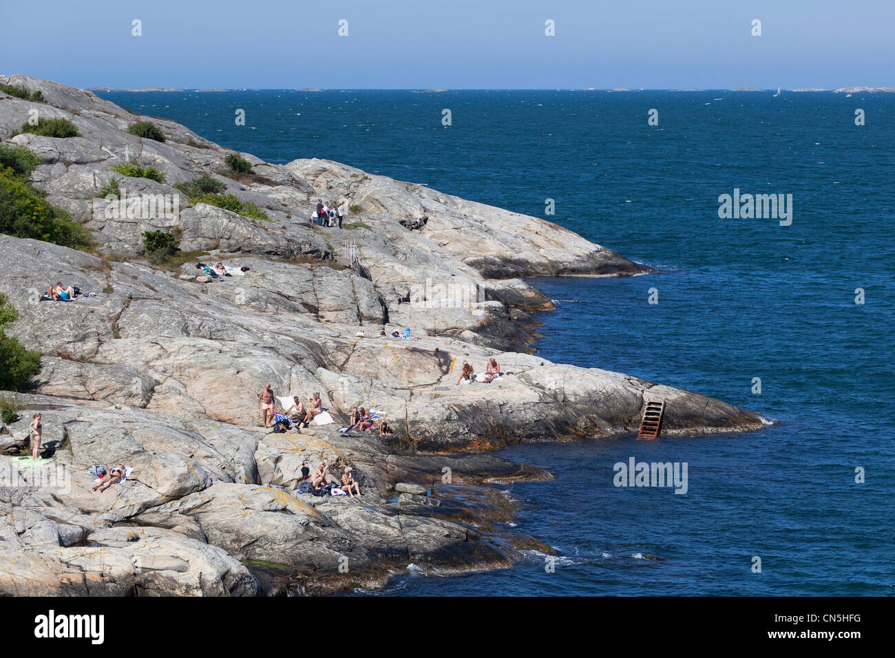 Girl sunbathing on rock sea hi-res stock photography and images - Alamy