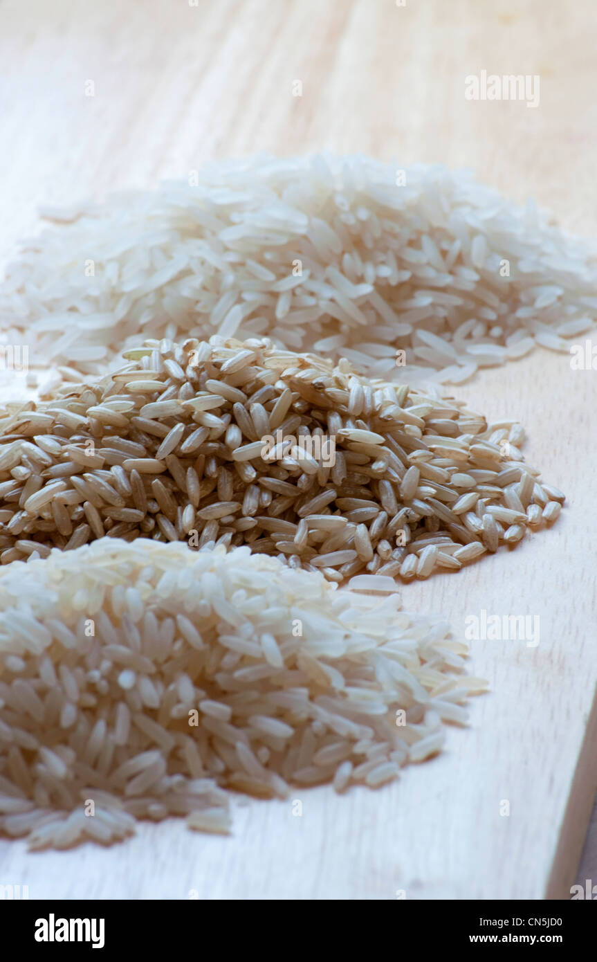 Piles of rice on a wooden board Stock Photo - Alamy