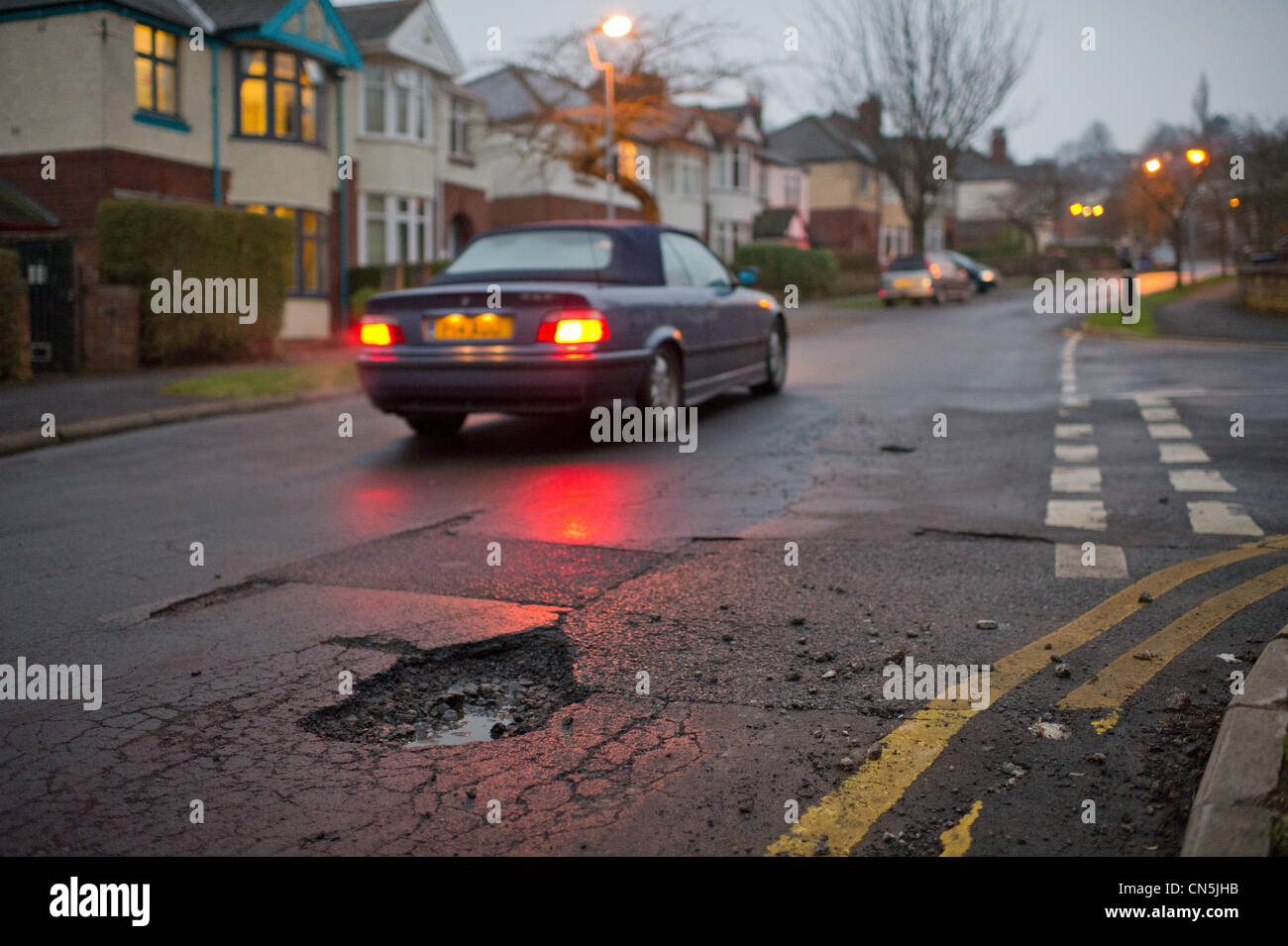 Potholes and patching in the road Stock Photo - Alamy