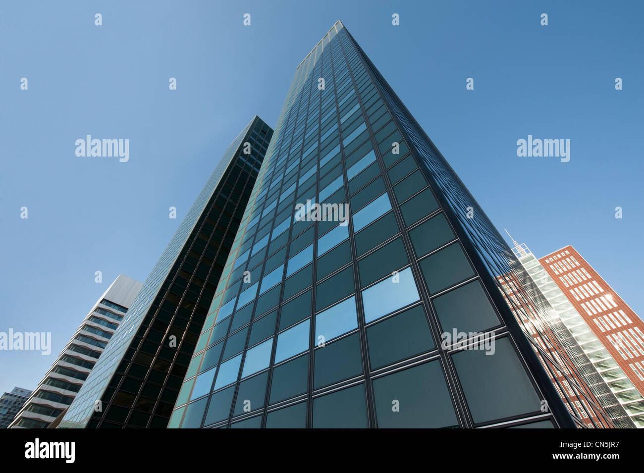 Group of tall office buildings with green high rise in business ...