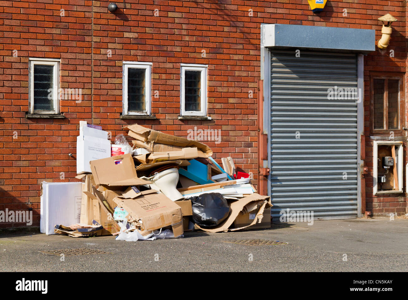 A pile of rubbish outside a small industrial unit Stock Photo - Alamy