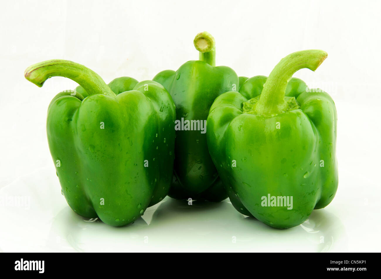 Three green peppers isolated on white Stock Photo - Alamy
