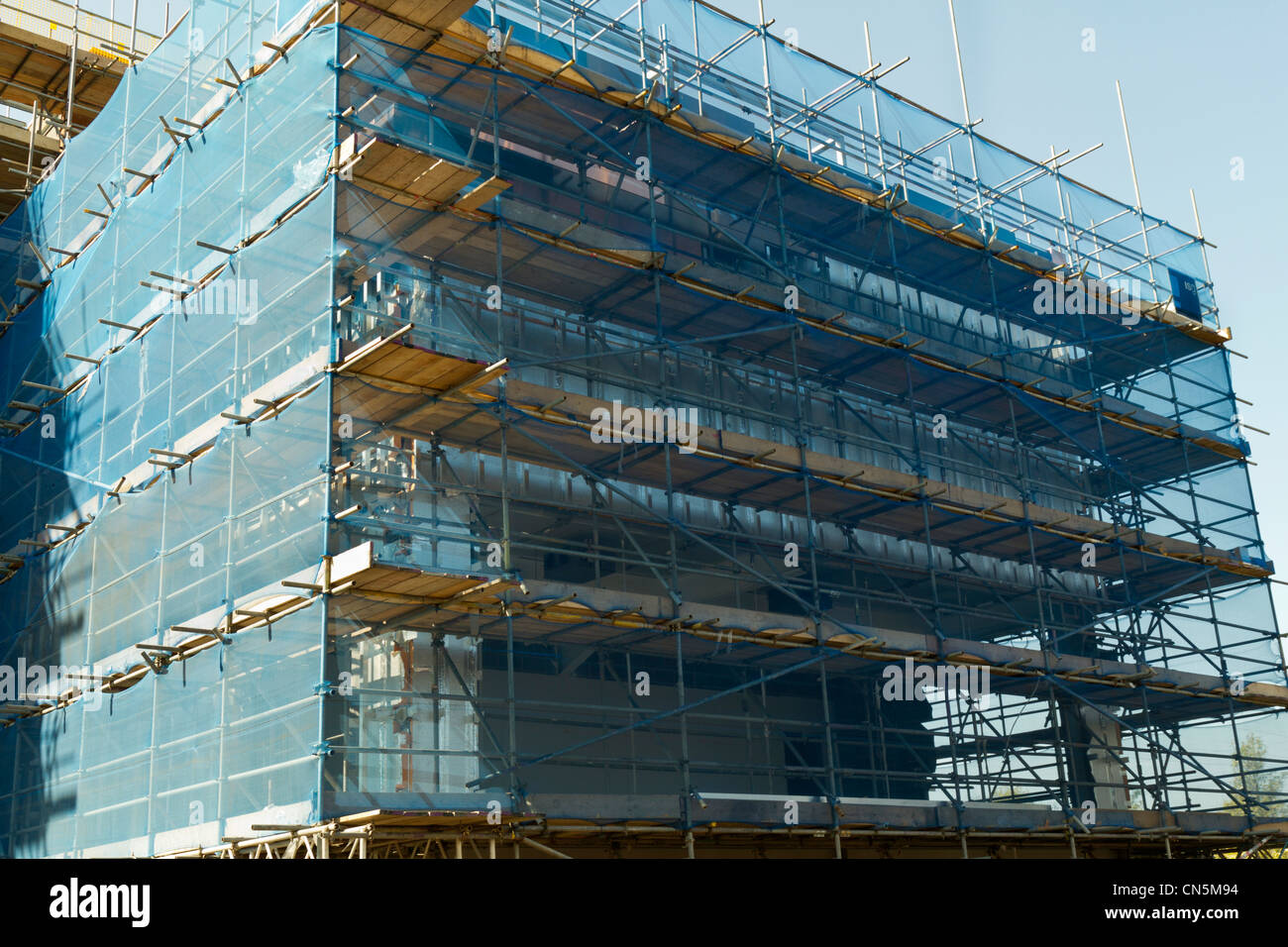 Scaffolding with protective netting on a construction site building ...