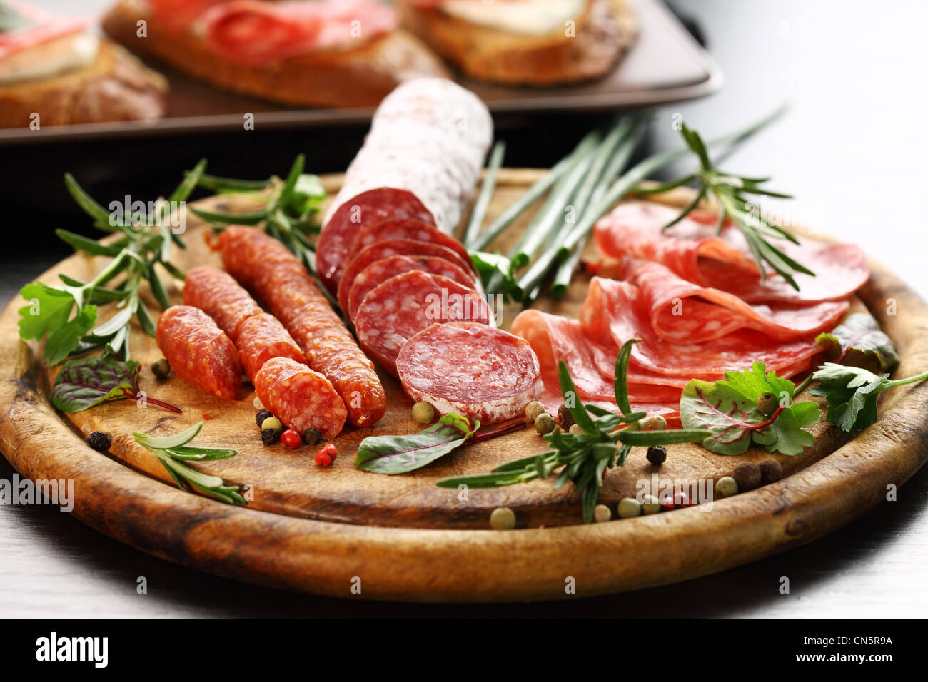 Different Italian ham and salami with herbs Stock Photo - Alamy