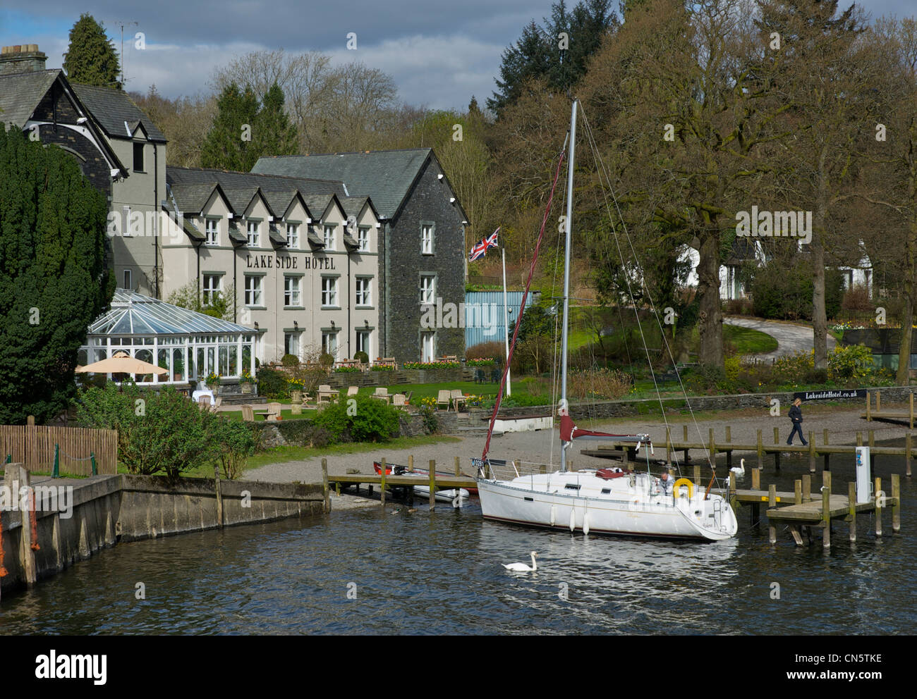 Woman walking on pier at Lakeside Hotel, Lake Windermere, Lake District ...