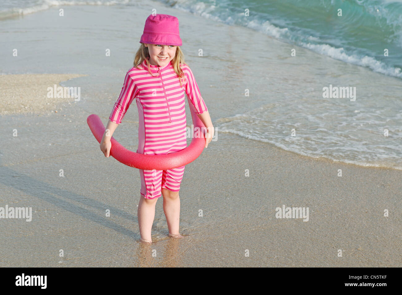 young child on beach vacation with sun protection suit and hat Stock ...