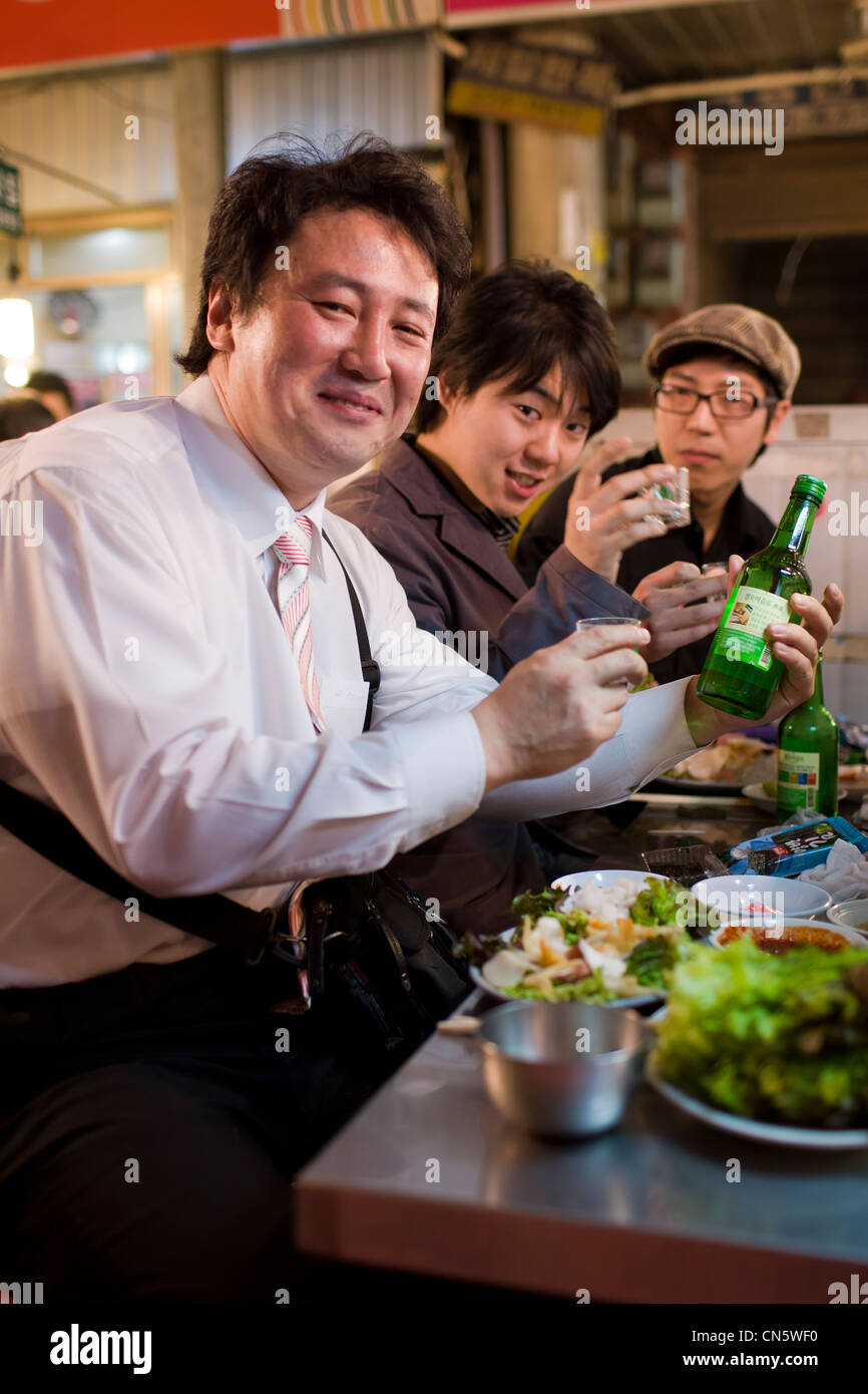 South Korea, Seoul, Dongdaemun District, young men drinking Korean ...