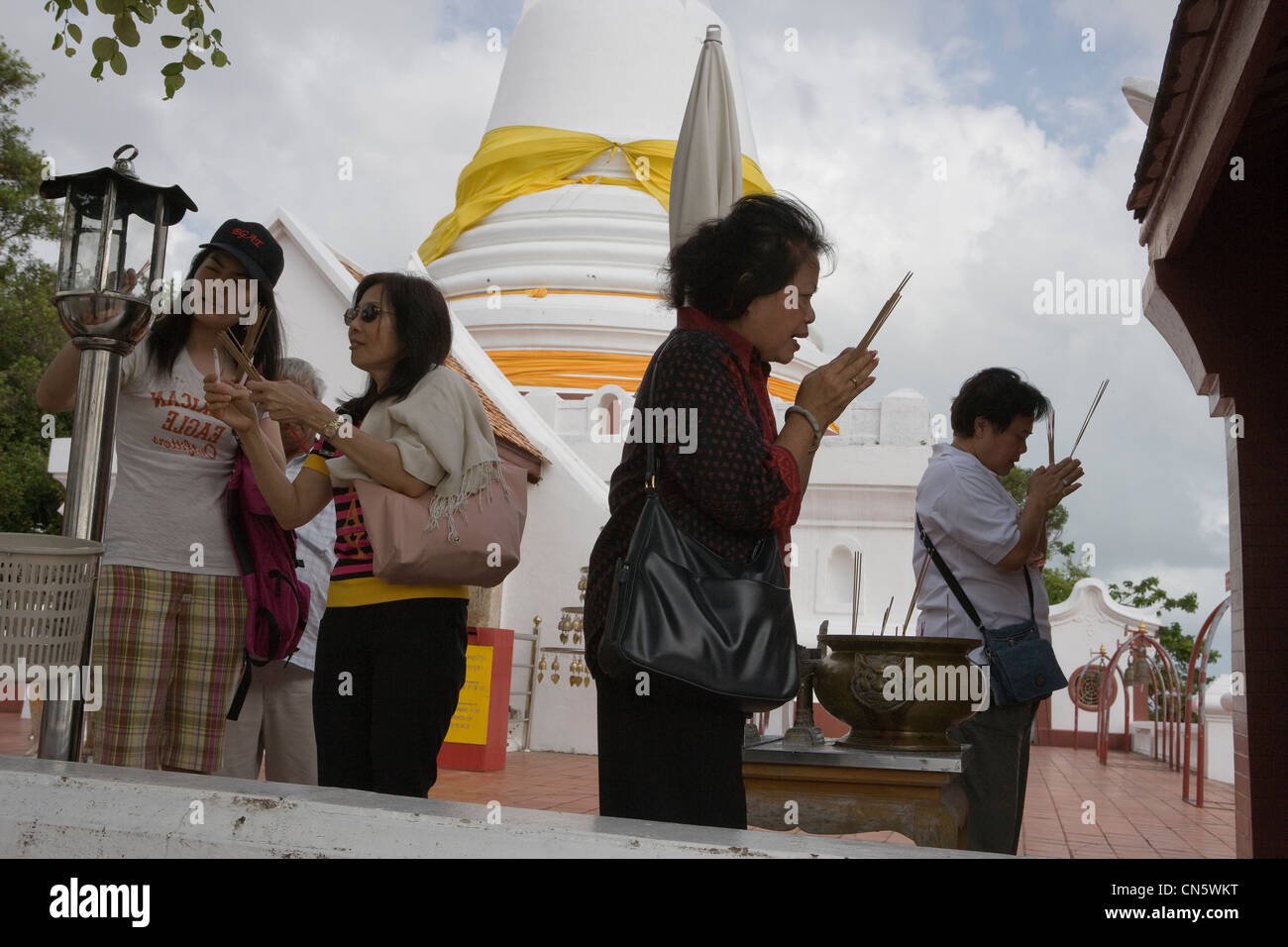 People praying at the ancient stupa and pagoda Phra Chedi Luang on top ...
