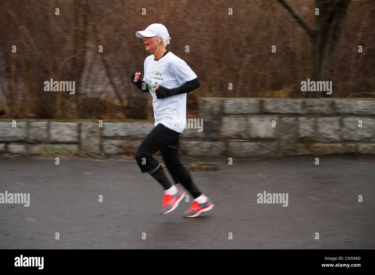 Girl running in bad weather Stock Photo - Alamy