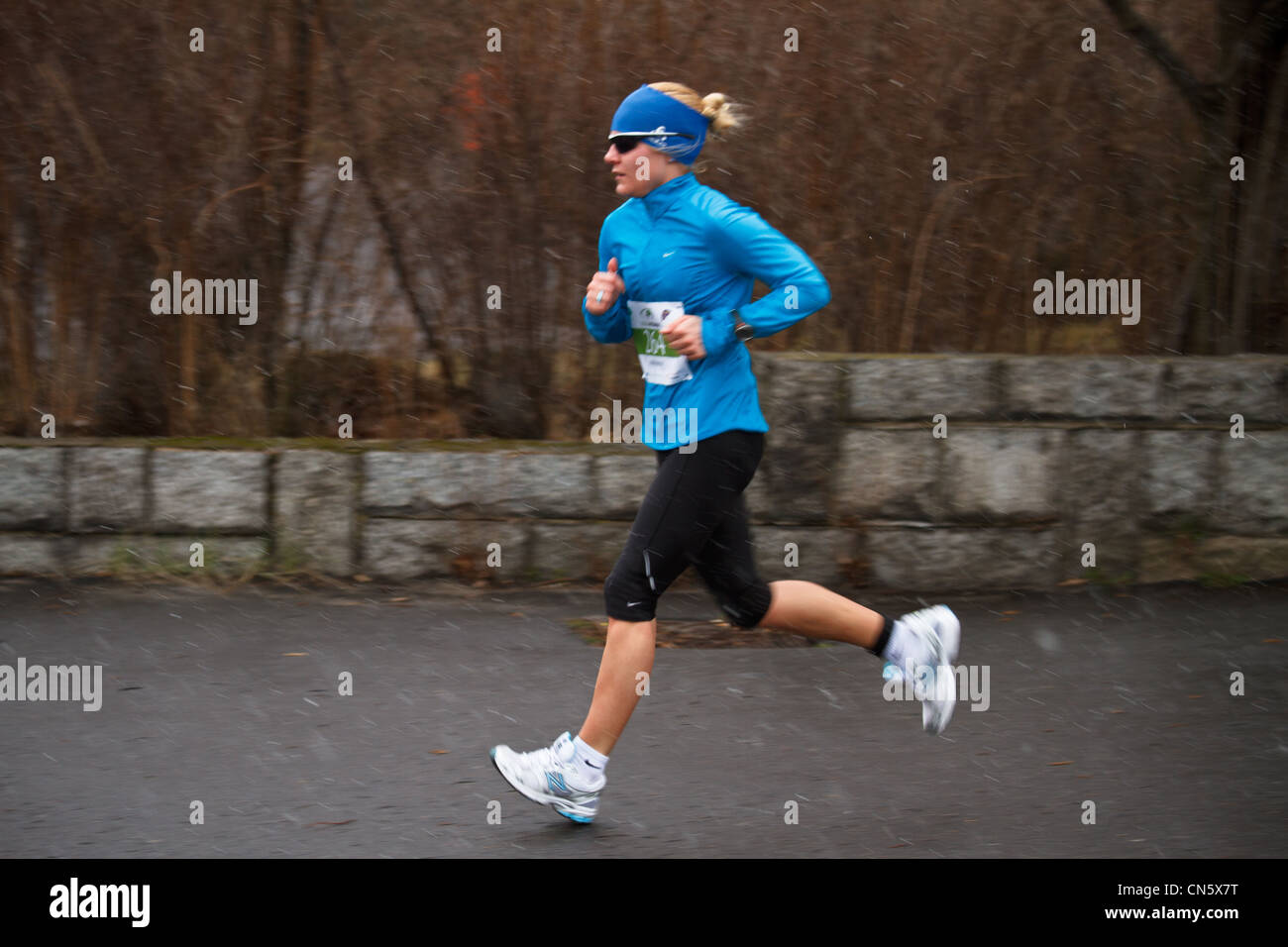 Girl running in bad weather Stock Photo - Alamy