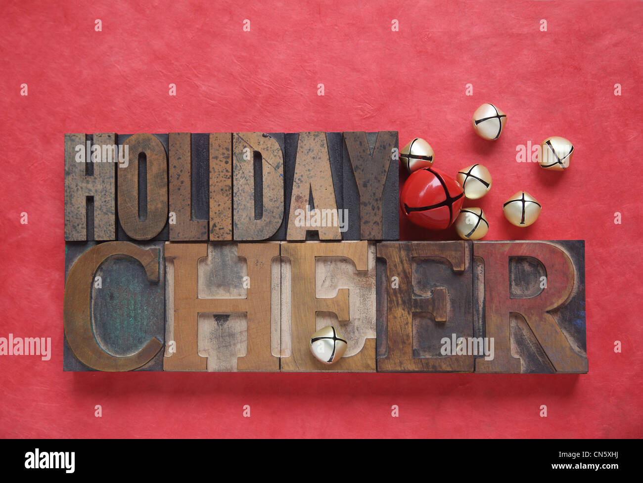 the words holiday cheer with bells on a red textured background Stock ...