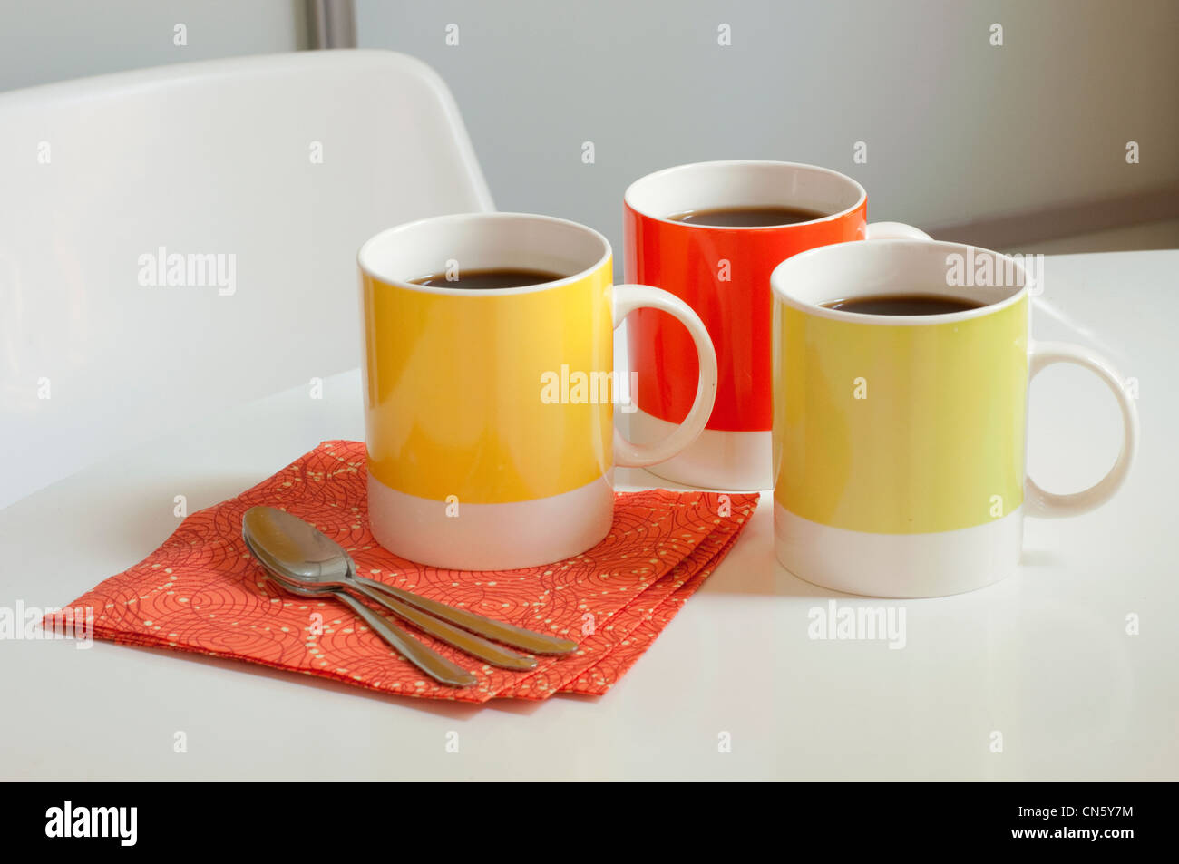Three mugs of coffee on a table Stock Photo - Alamy