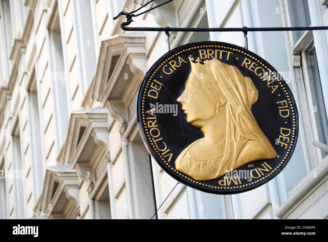 Queen Victoria one penny replica sign outside an a coin collectors shop ...