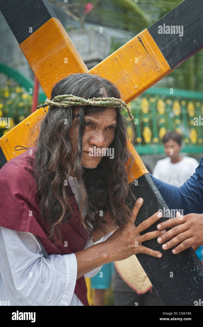Main character carries the cross to the Cutud crucifixion site during ...