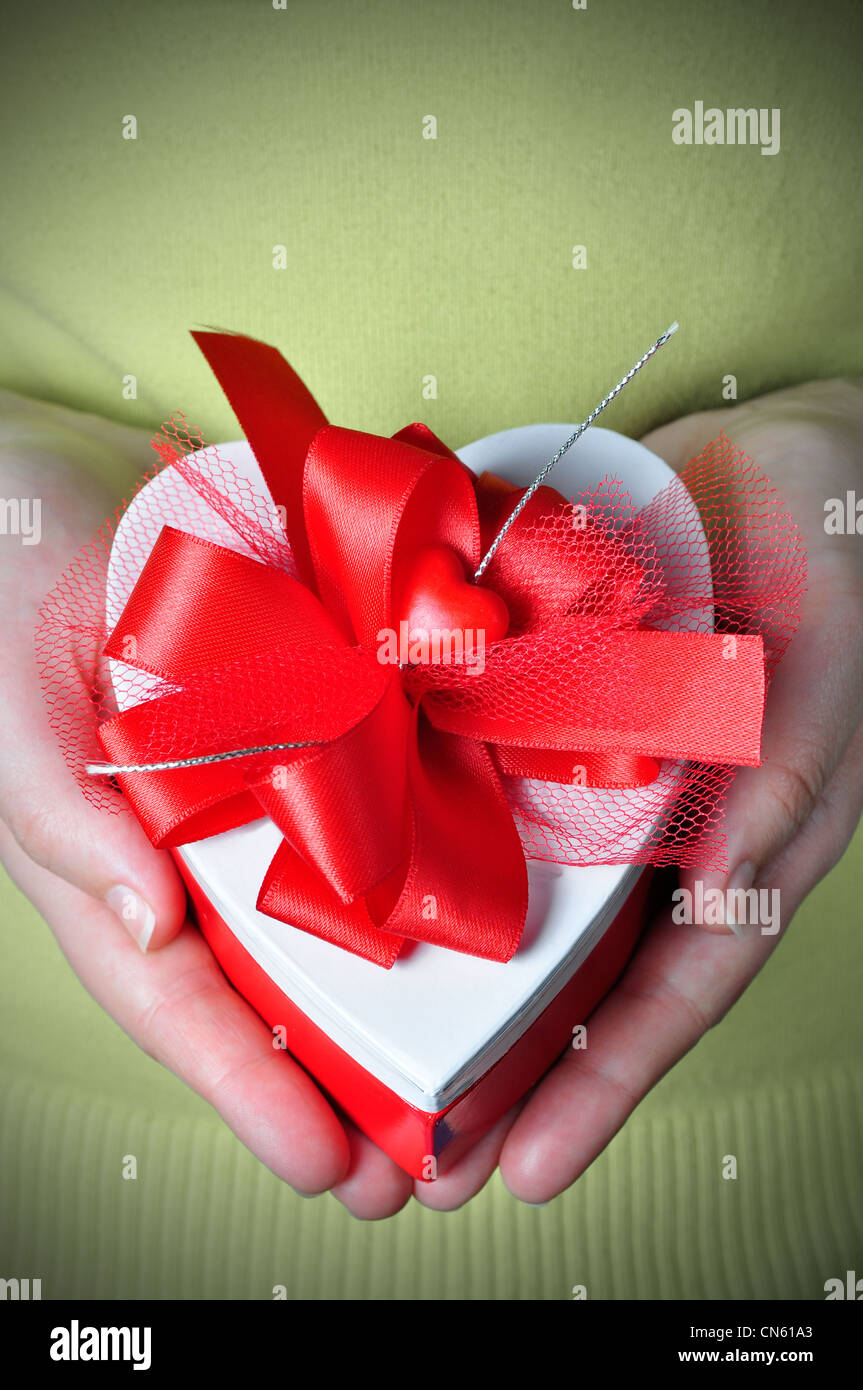 Two hands hold a heart shaped box of chocolates Stock Photo - Alamy
