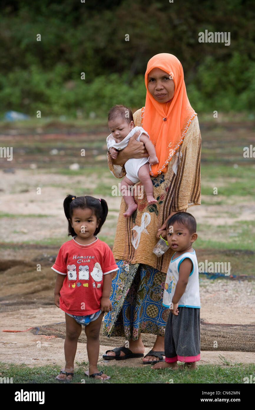 Wife of a fisherman and her young children at a fishing village close ...