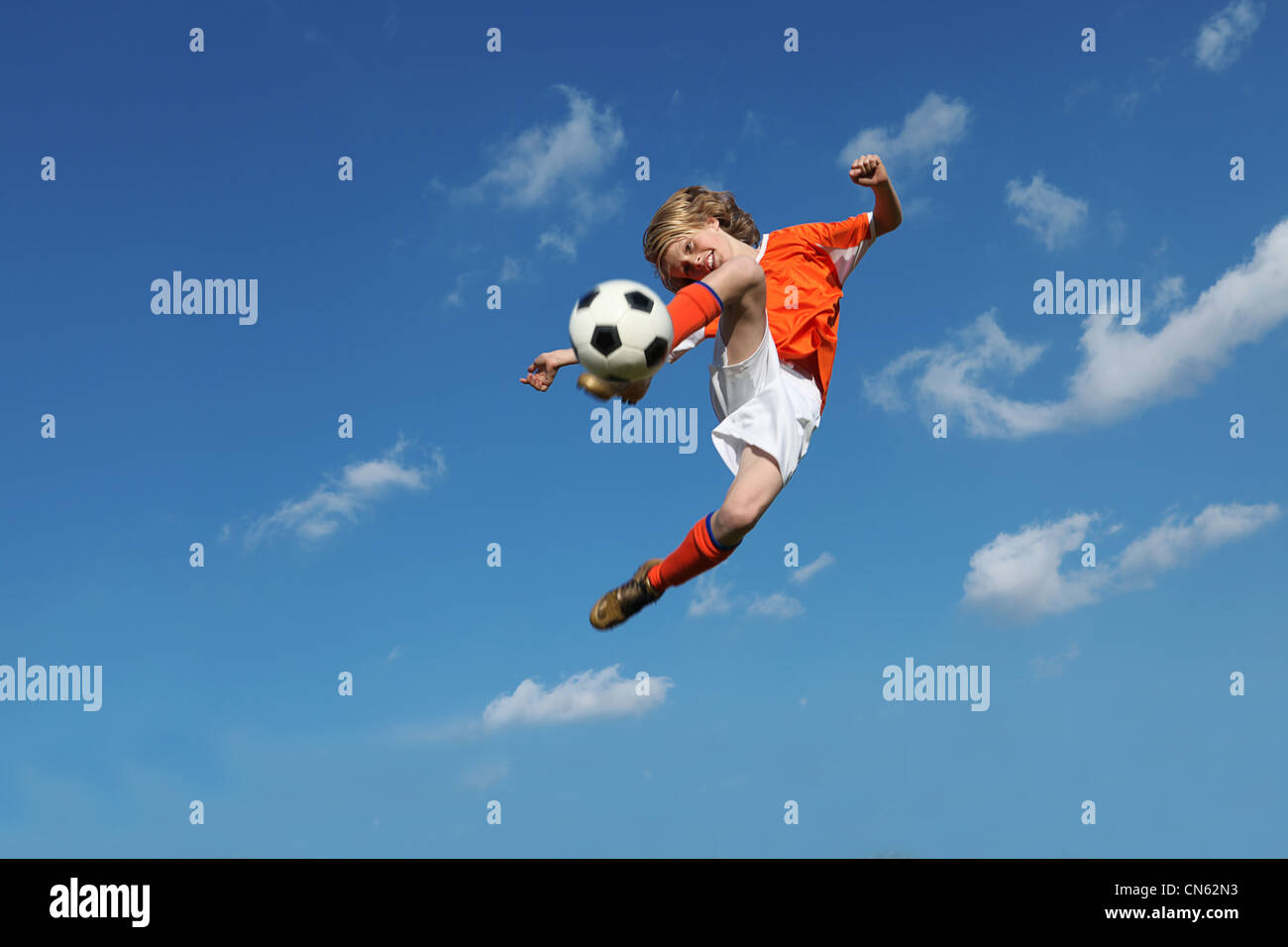 Leaping footballer hi-res stock photography and images - Alamy