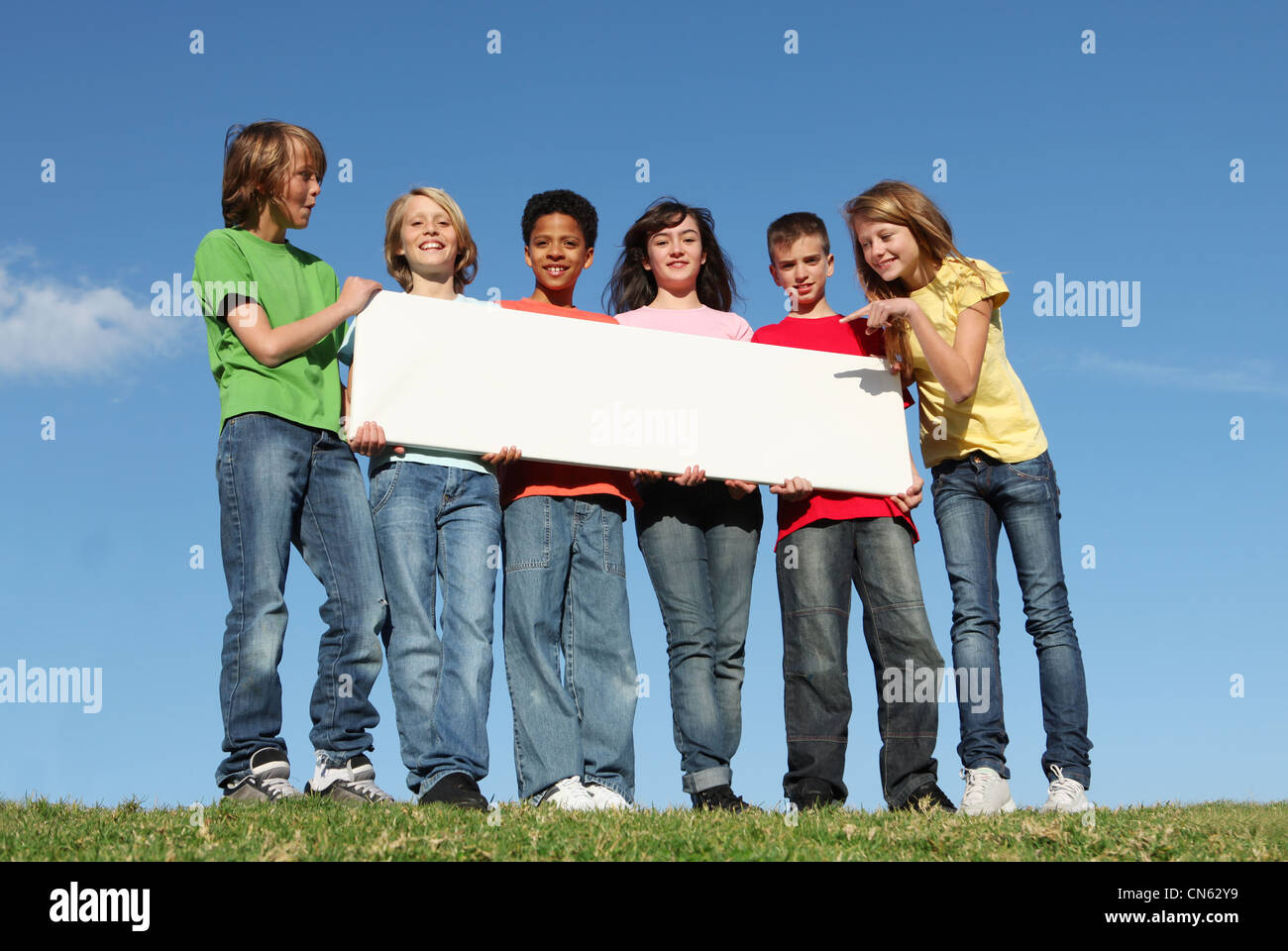 happy group of diverse teens or kids at summer camp holding blank sign ...