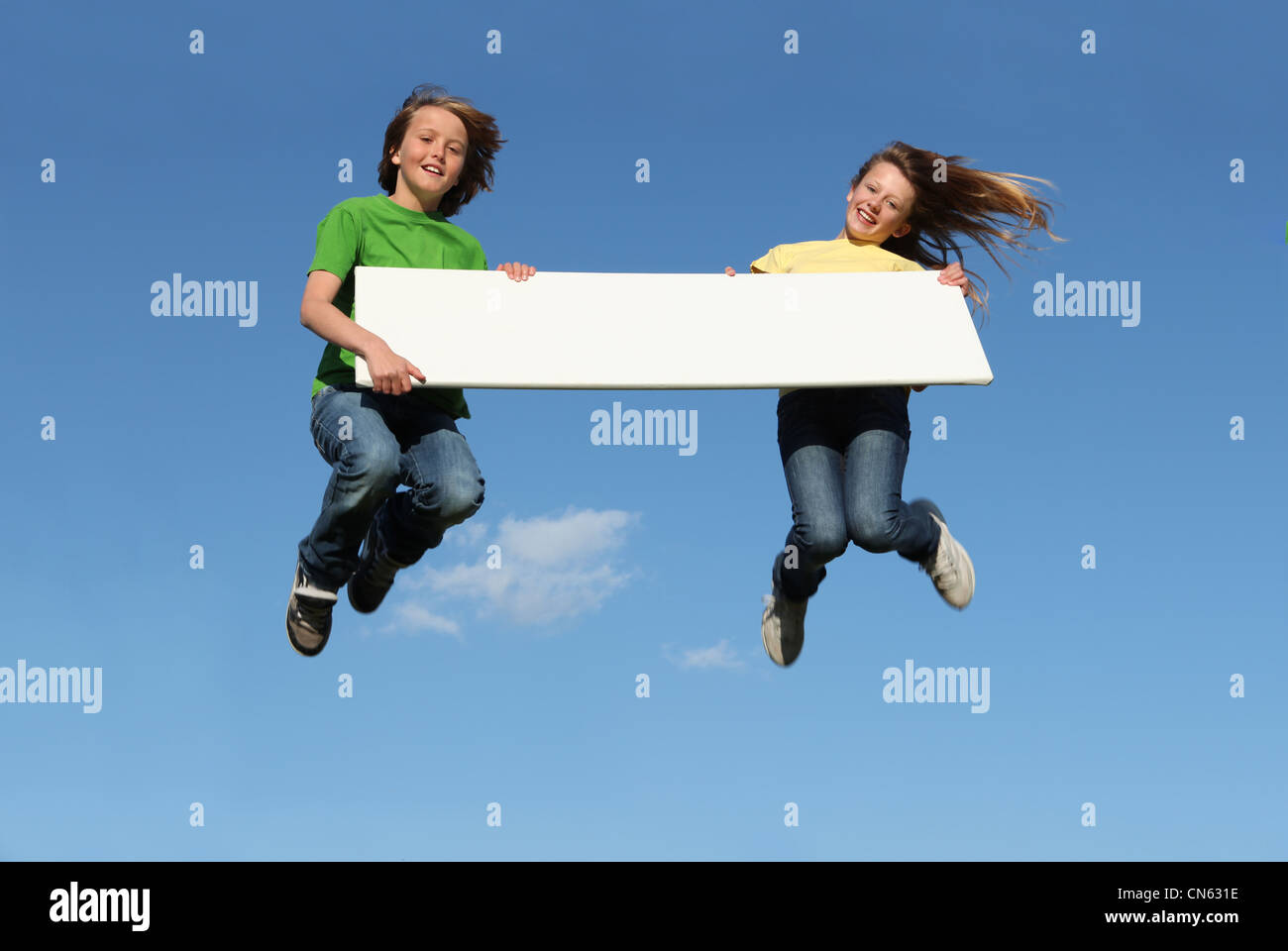 kids jumping holding blank sign Stock Photo - Alamy