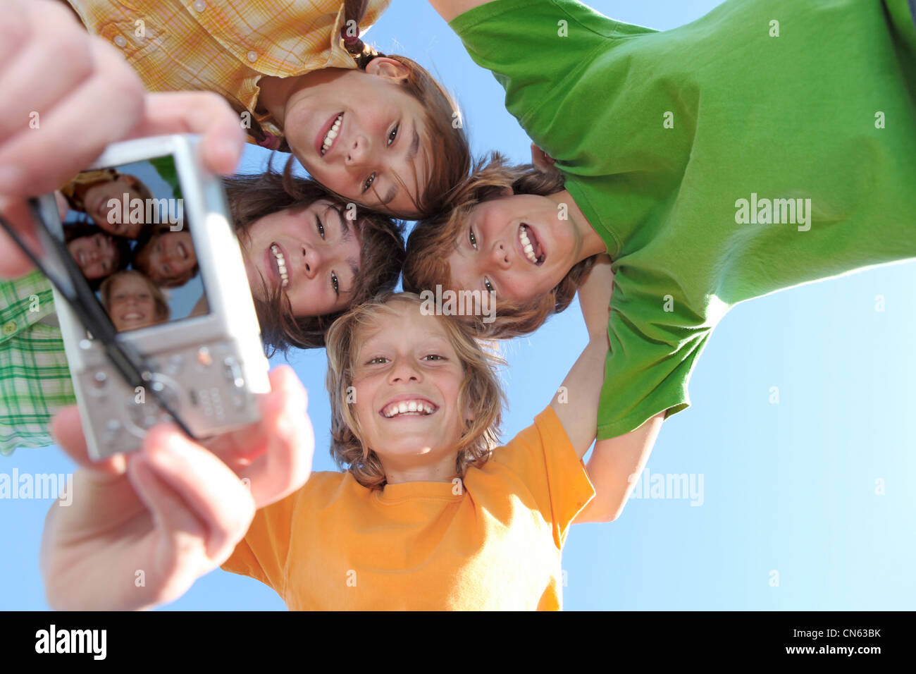 white teeth and smiles, happy group of kids taking photo with camera ...