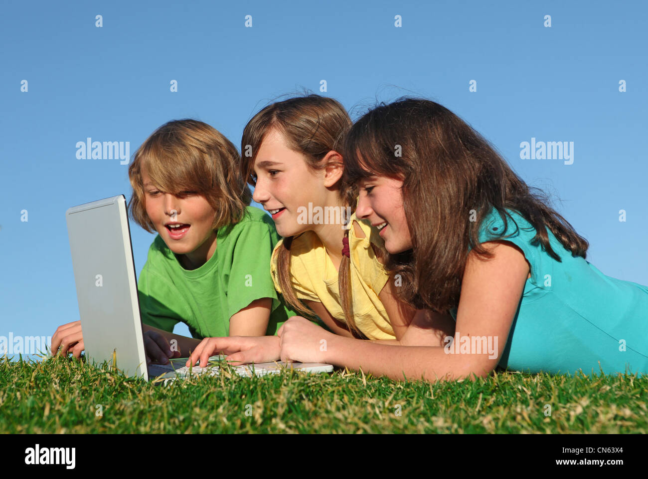 group of kids with computer on internet Stock Photo - Alamy