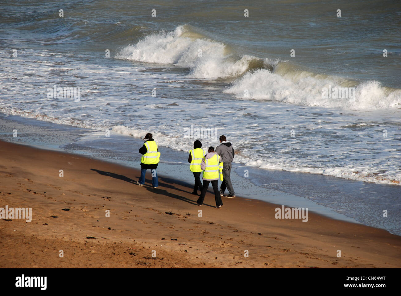 Walkers on the beach Stock Photo - Alamy