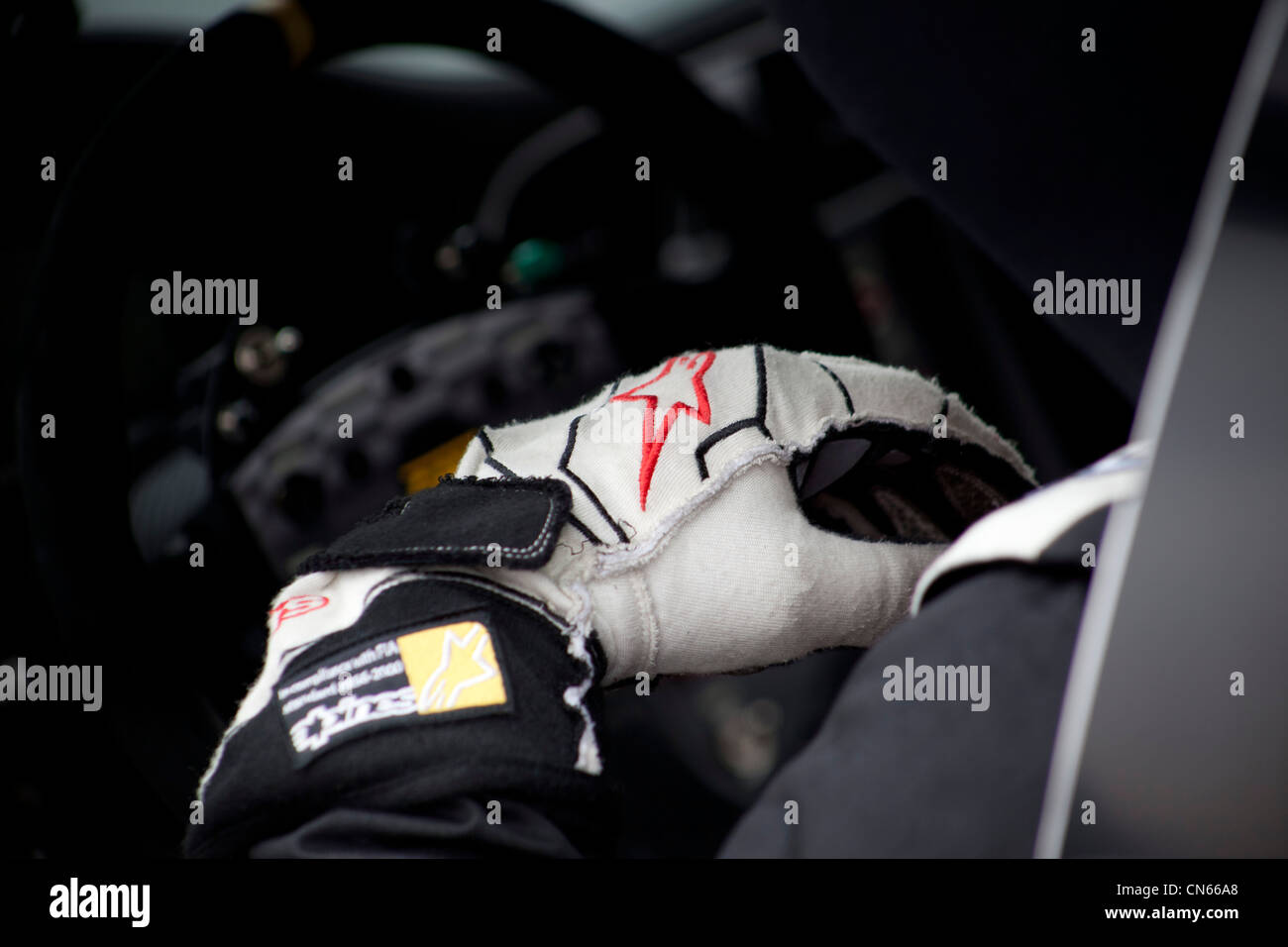 Racing driver preparing for a race Stock Photo - Alamy