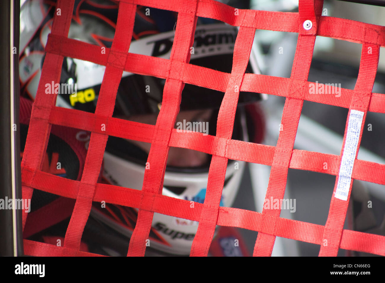 Racing driver preparing for a race Stock Photo - Alamy