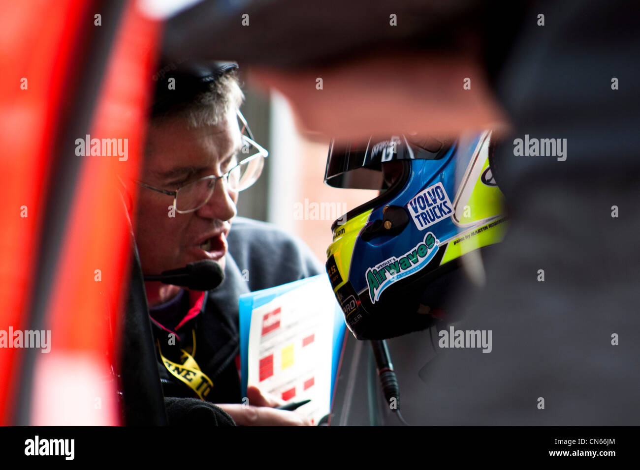 Racing driver preparing for a race Stock Photo - Alamy