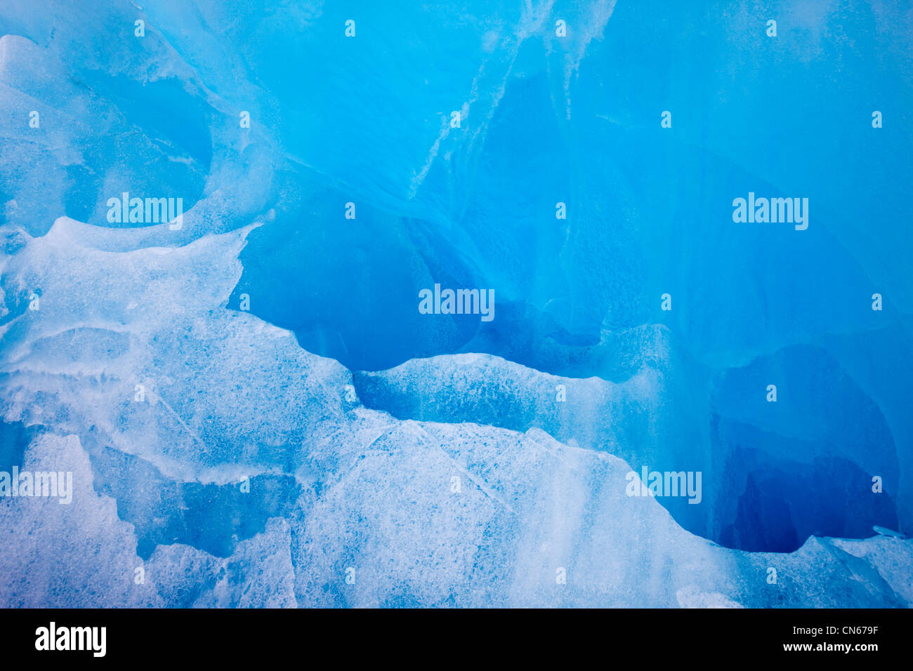Norway Svalbard Spitsbergen Deep blue iceberg floating near face of ...